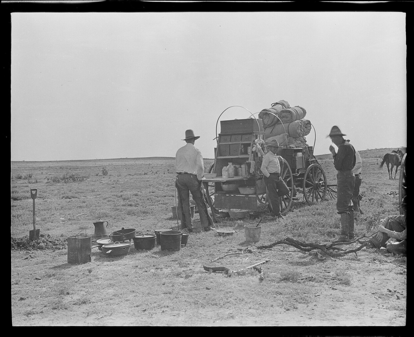 Some Spur Ranch cowboys resting and working around the chuck wagon ...