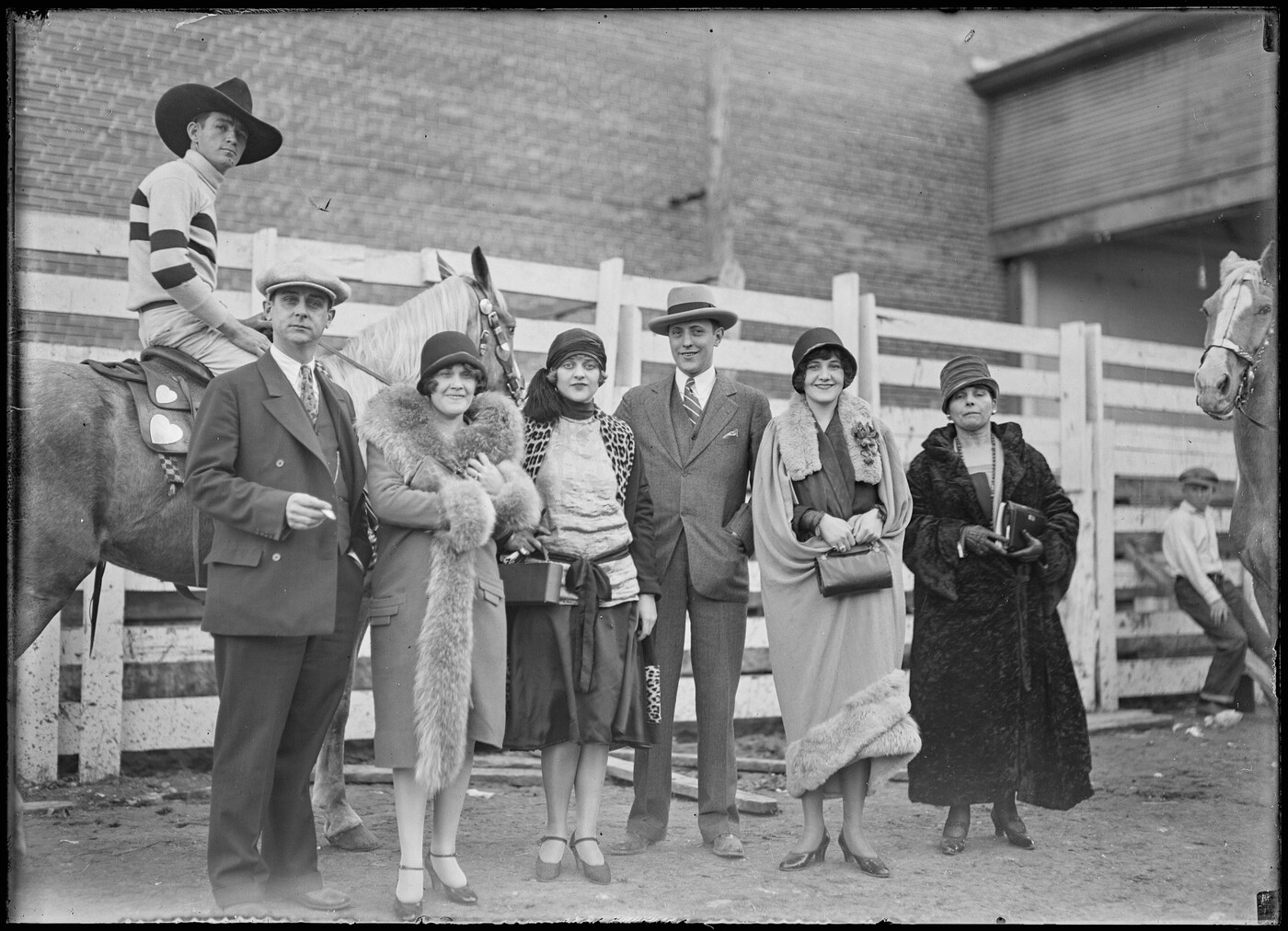 Posed photograph of group attending a rodeo somewhere in the Southwest ...
