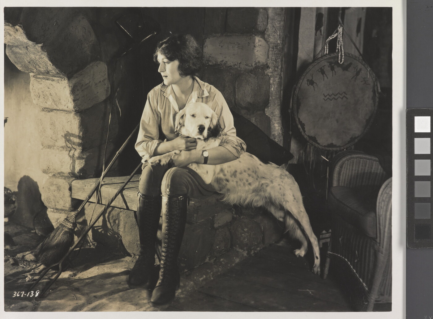 [Dorothy Cumming sitting by fireplace holding dog in lap, "Affairs of ...