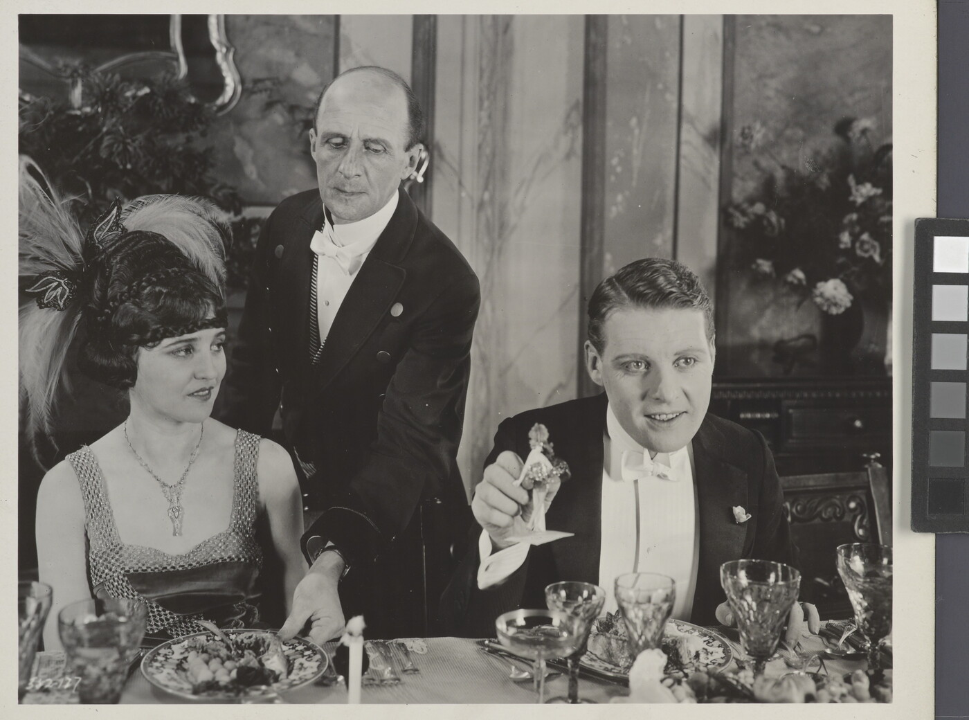 [Forrest Stanley holding figurine, waiter serving Agnes Ayres, formal ...