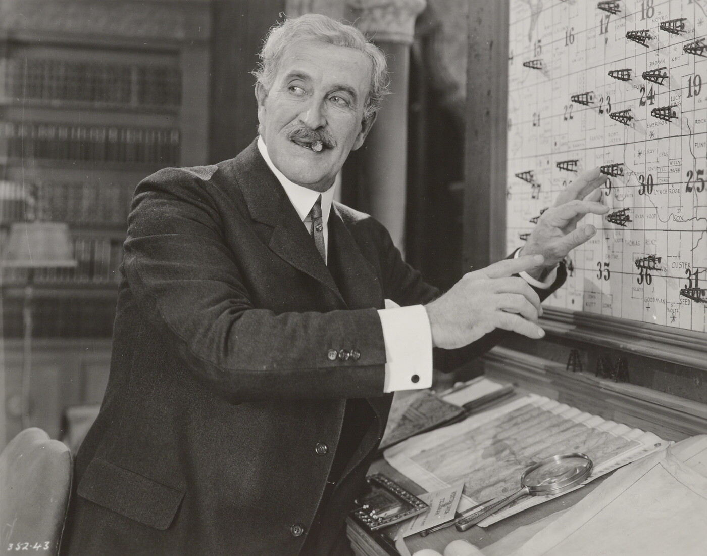 [Theodore Roberts with map of oil wells, "Forbidden Fruit"] | Amon ...