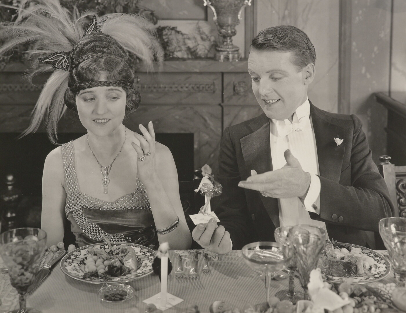 [Forrest Stanley showing figurine to Agnes Ayres, formal dinner scene ...