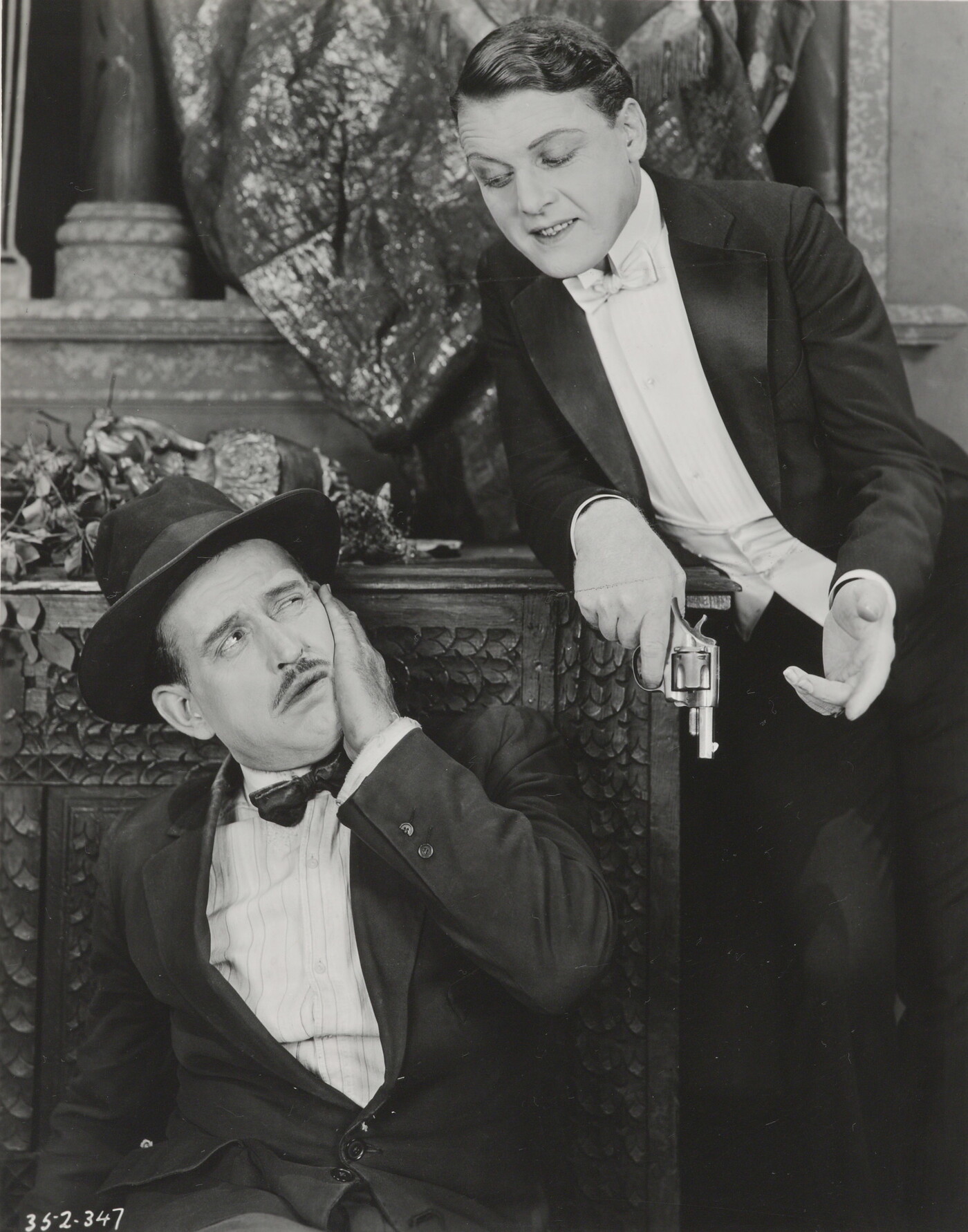 [Forrest Stanley holding seated Clarence Burton at gunpoint, "Forbidden ...