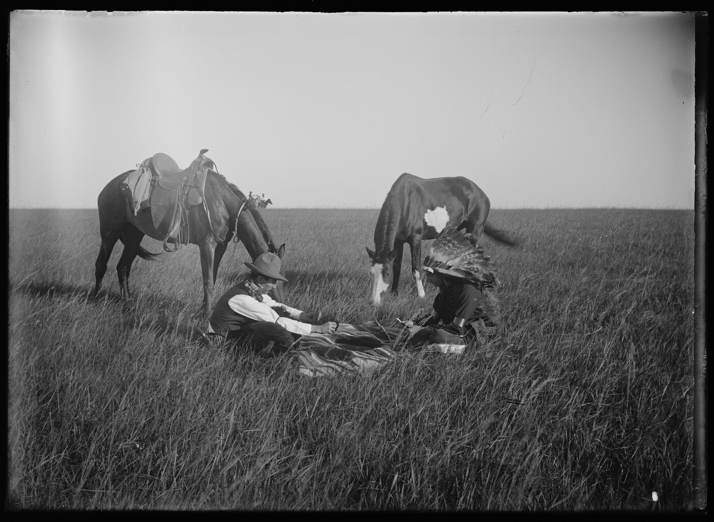 [Cowboy and "Indian" (Erwin E. Smith) playing cards near Bonham, Texas ...