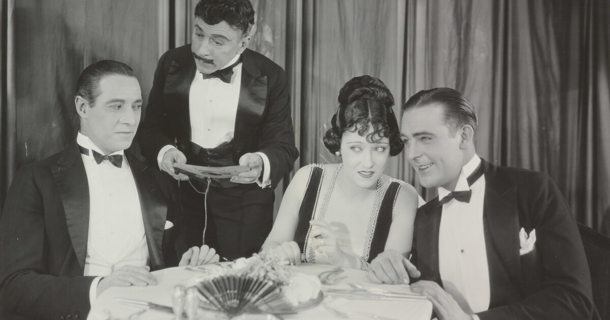 [Elliot Dexter, Gloria Swanson and Wallace Reid around dinner table ...
