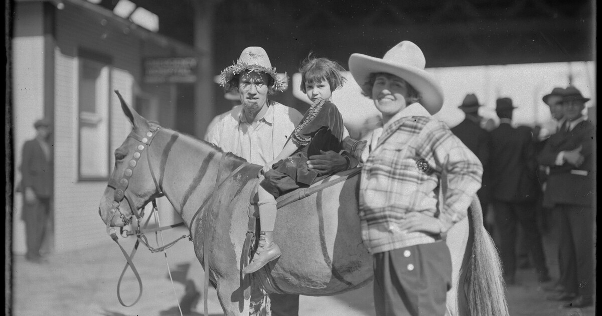 [Rodeo contestant Ruth Roach with rodeo clown and child sitting on mule ...